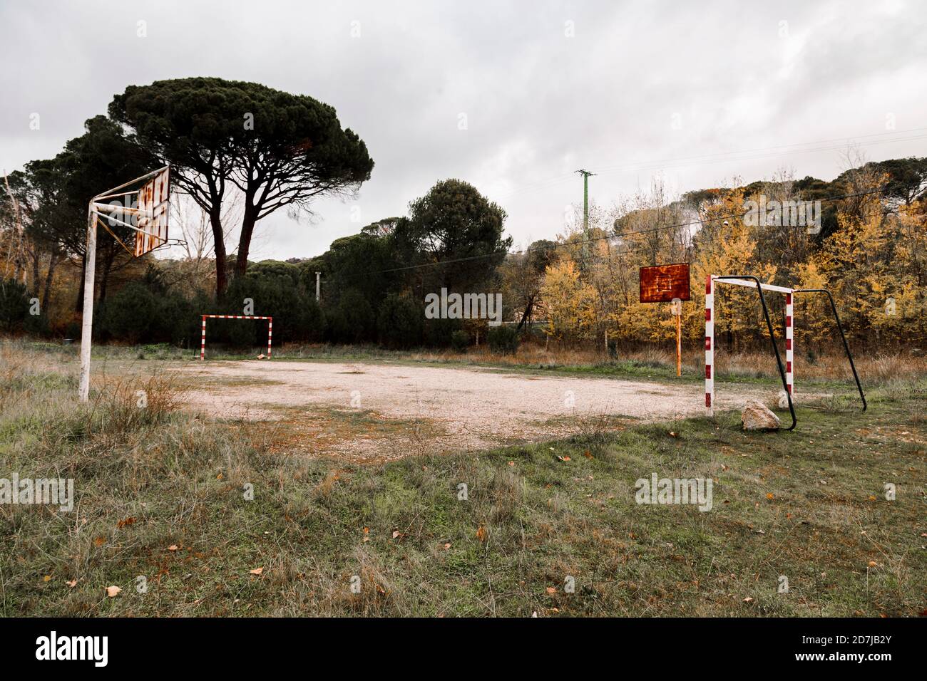 Small abandoned sports field with goals and basketball hoops Stock ...