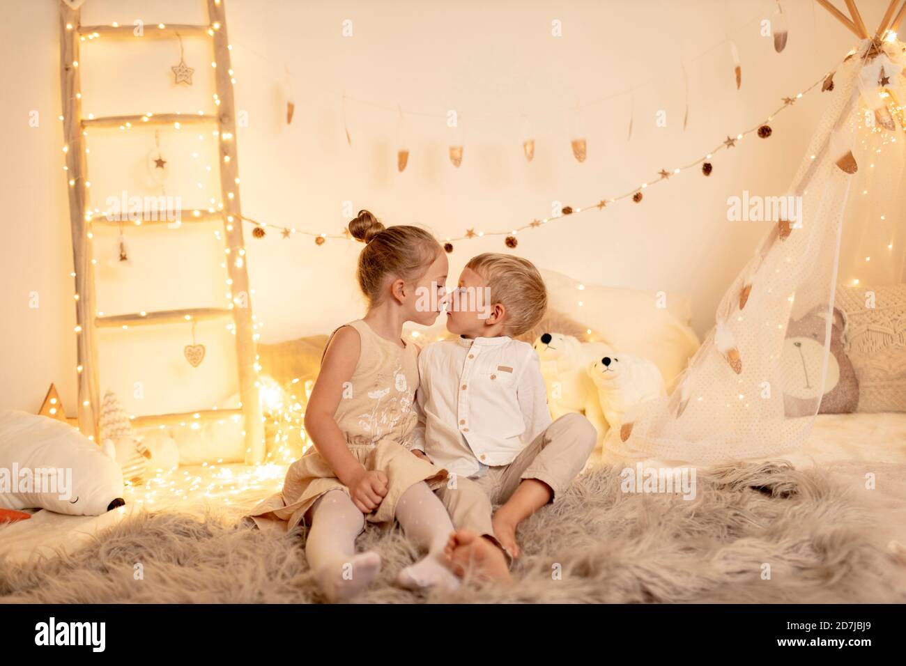 Brother and sister nuzzling nose with each other in room Stock Photo ...