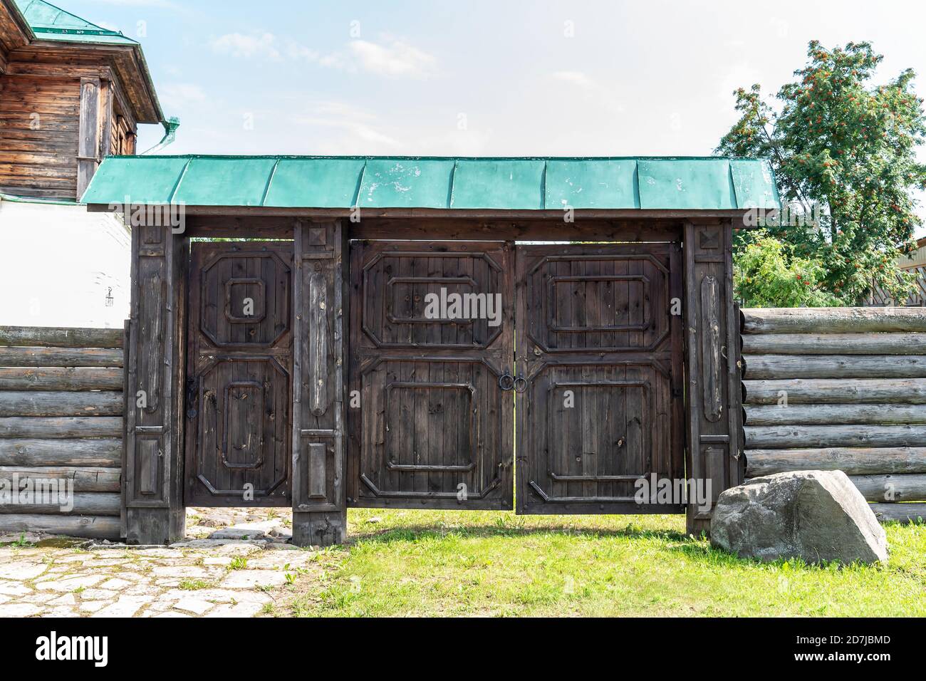 Weathered gate with green roof and fence near rural house Stock Photo ...