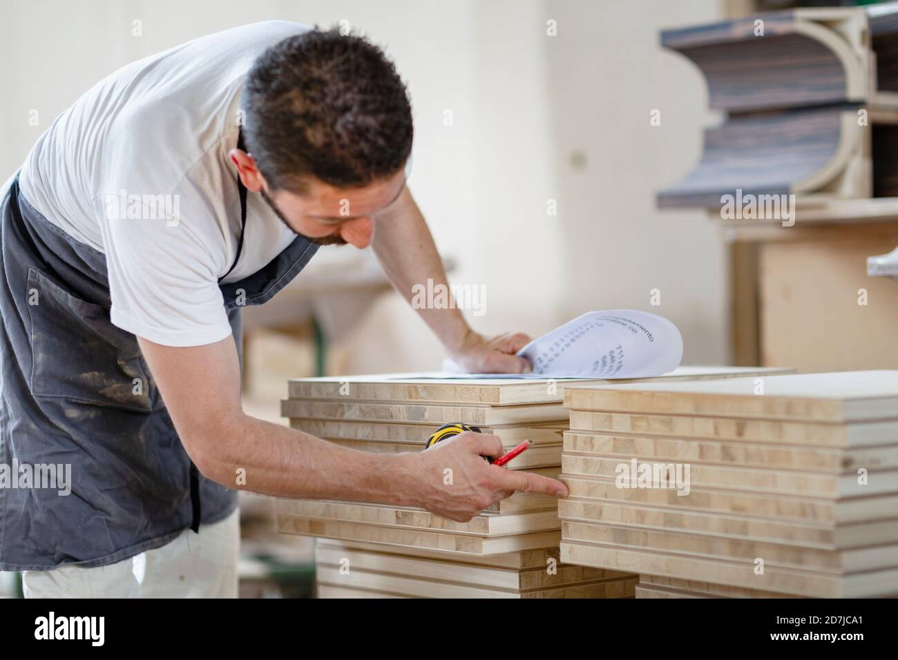 Man counting wood plank while working at workshop Stock Photo - Alamy
