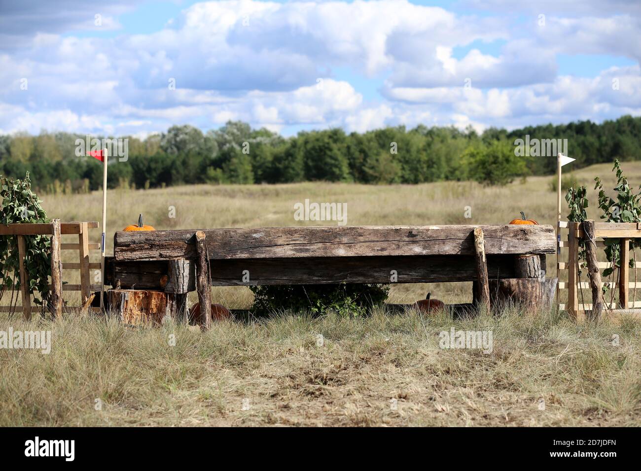 Jumping horse log obstacle on cross country course without riders as a ...
