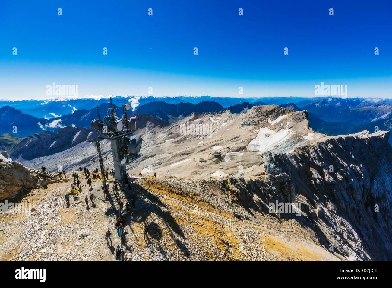 Austria, Tyrol, People waiting around ski lift in Wetterstein Mountains ...
