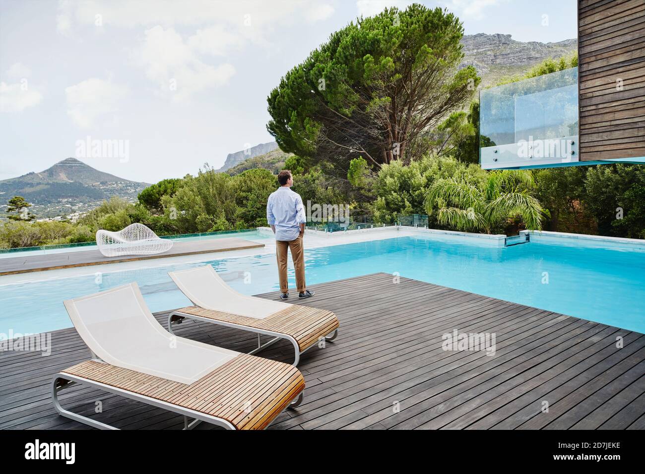 Mature man with hands in pockets looking at view while standing near ...
