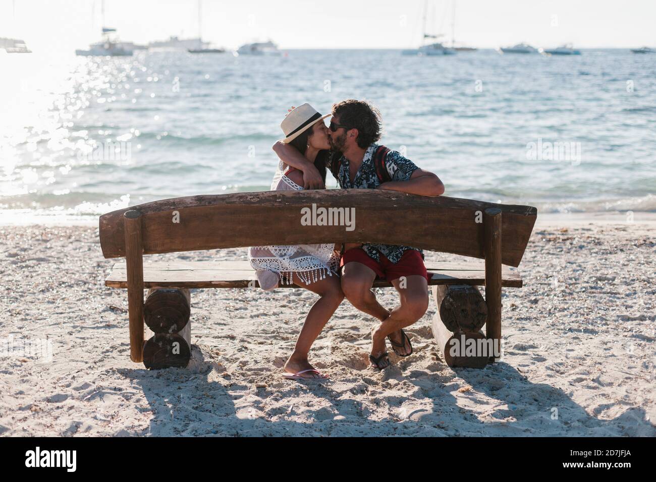 Couple on bench kissing in hi-res stock photography and images - Alamy