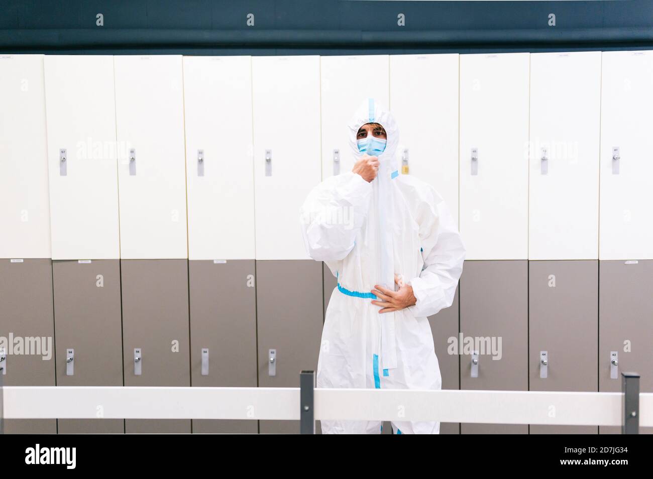 Healthcare man standing against locker in hospital Stock Photo - Alamy