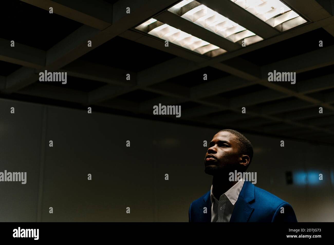 Man under fluorescent light hi-res stock photography and images - Alamy