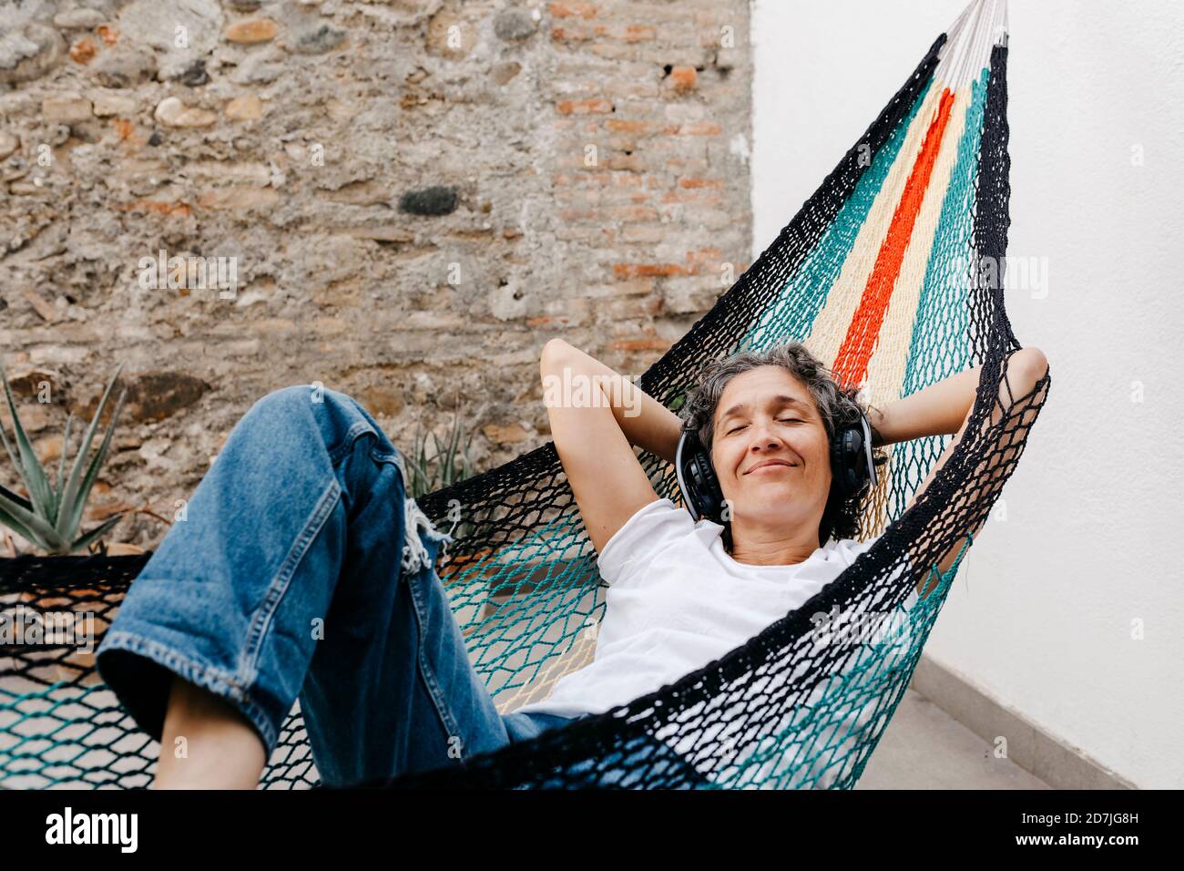 Woman relaxing hammock wall hi-res stock photography and images - Alamy