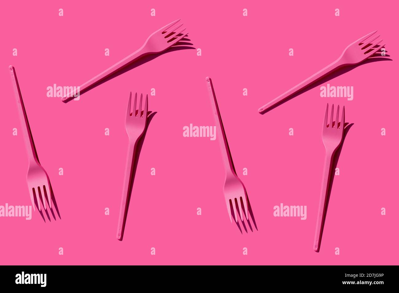 Pattern of pink plastic forks against pink background Stock Photo - Alamy