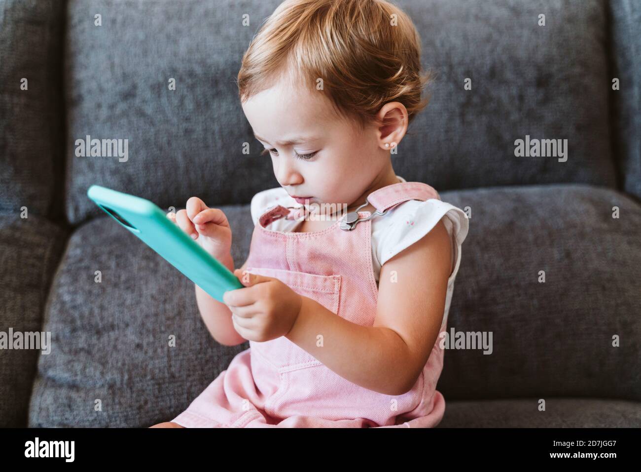 Children using technology on sofa hi-res stock photography and images ...