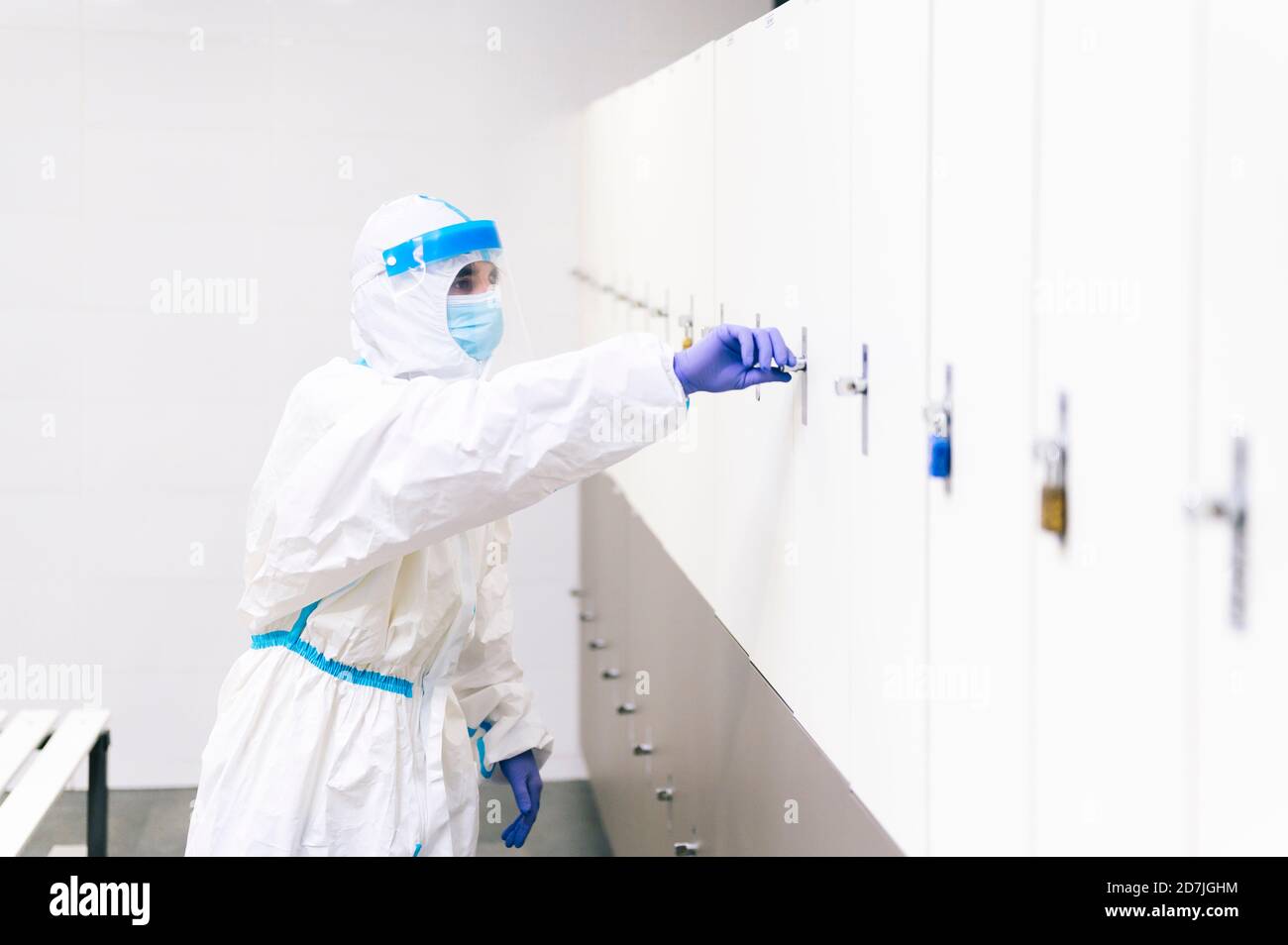 Healthcare man unlocking locker while standing in hospital Stock Photo ...