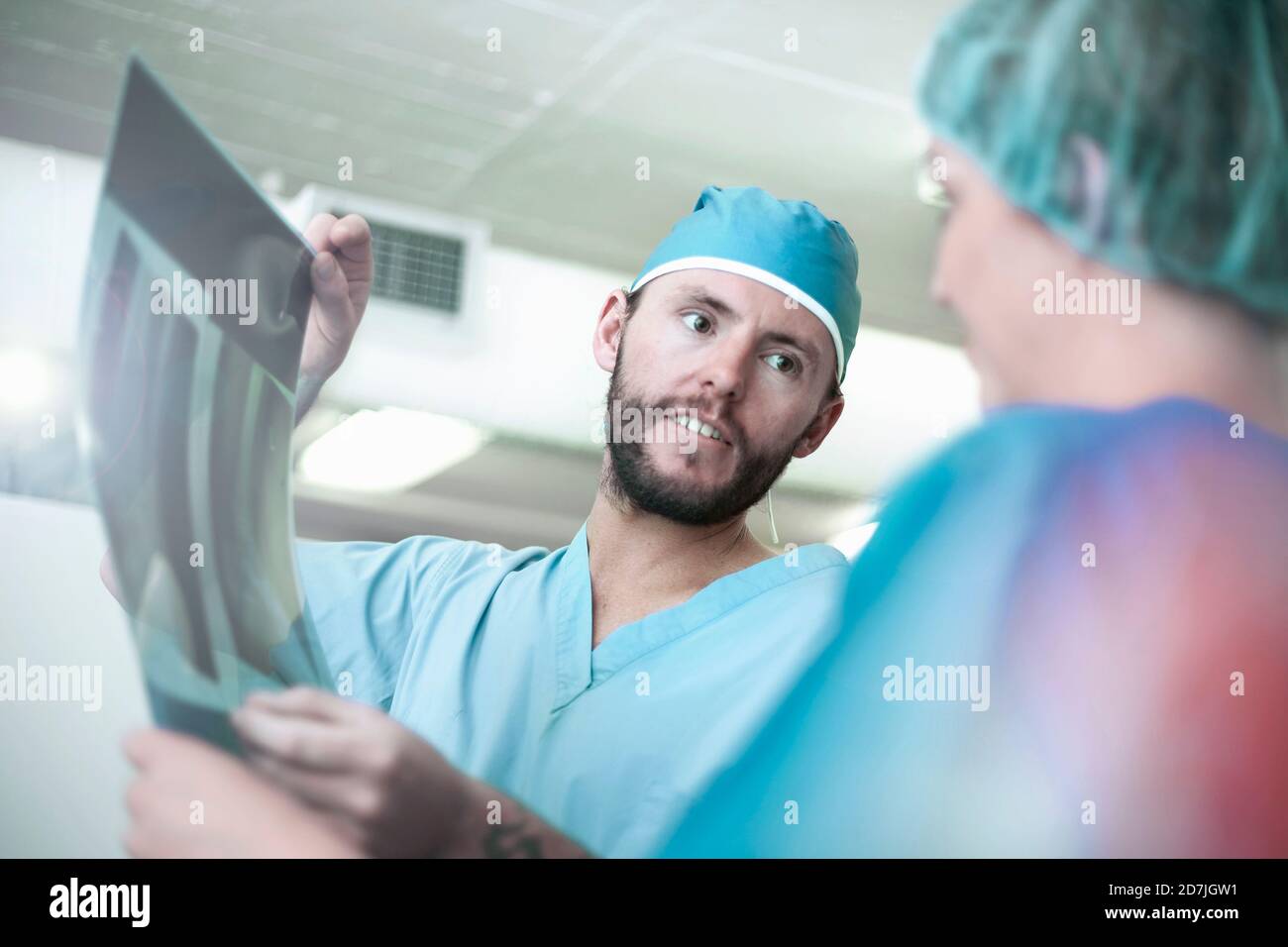 Male and female surgeons discussing over x-ray image in hospital Stock ...