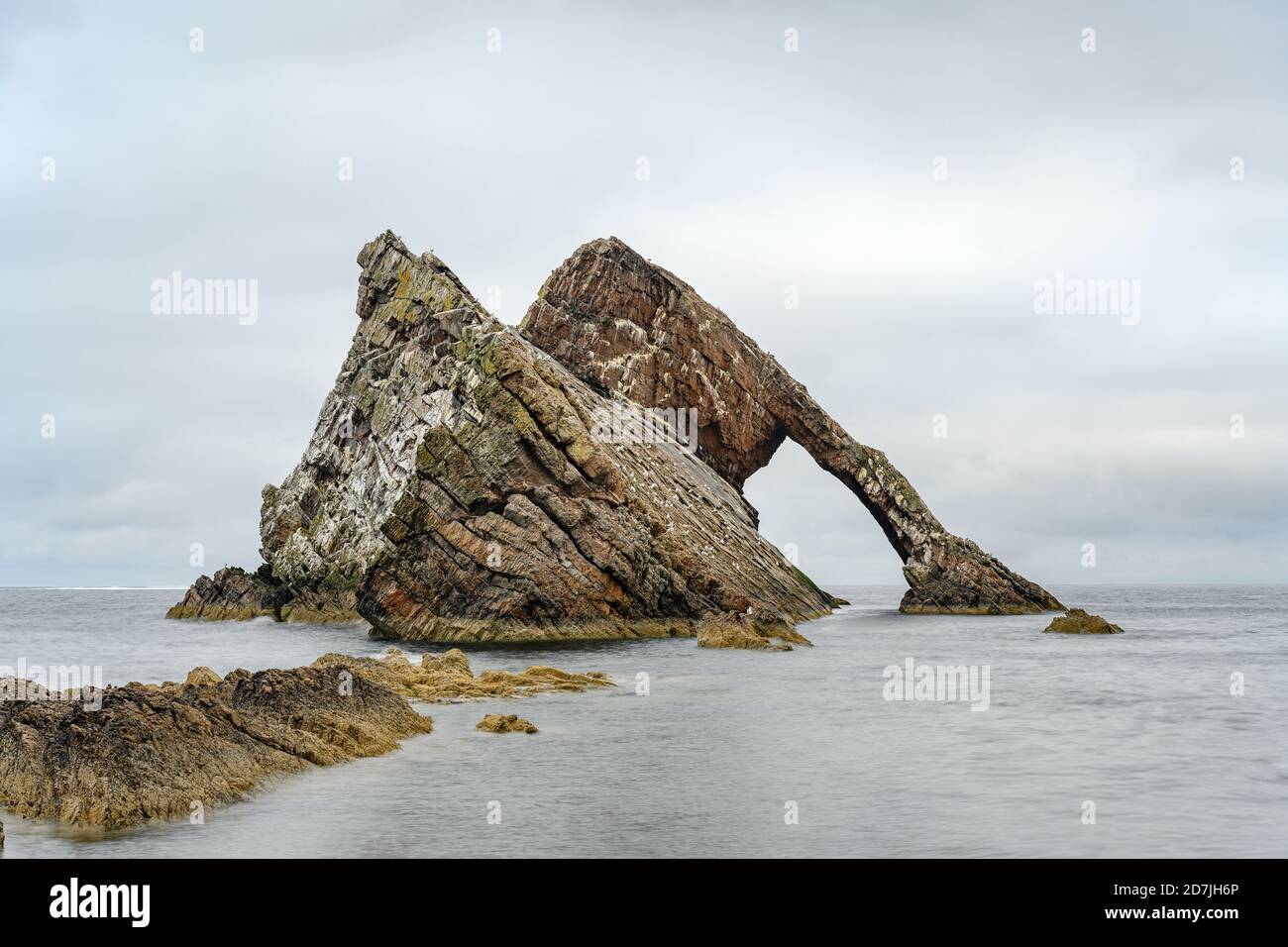 Natural arch Bow Fiddle Rock, Portnockie, Moray Firth, UK Stock Photo ...