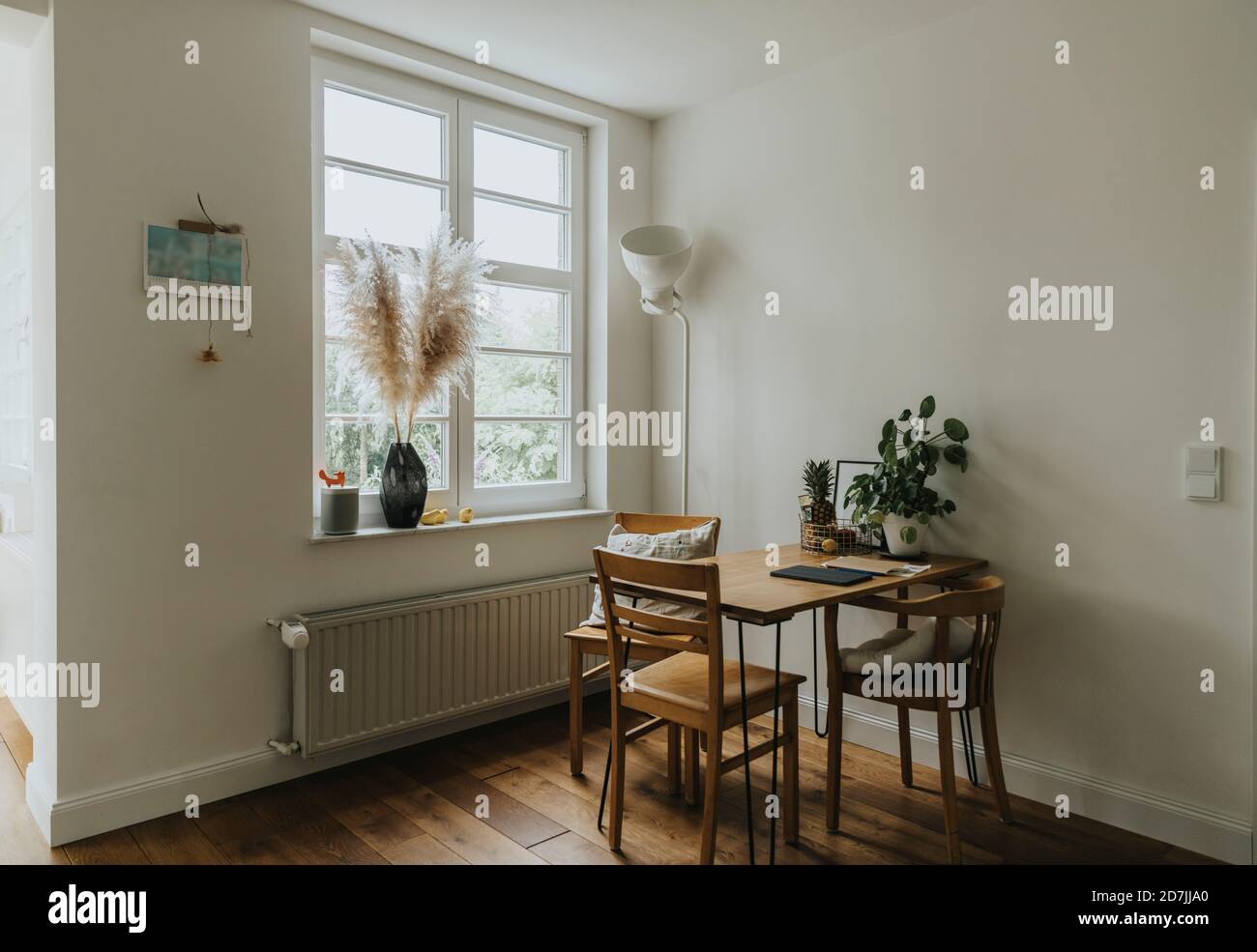 Modern interior of room with table and chairs by window at old house ...
