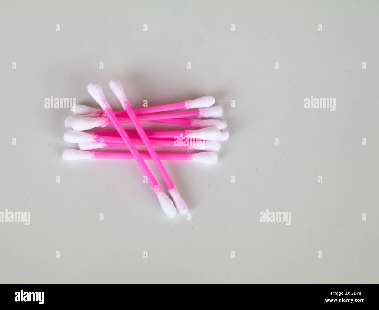 Rose color ear cleaning buds in packets, against white background ...