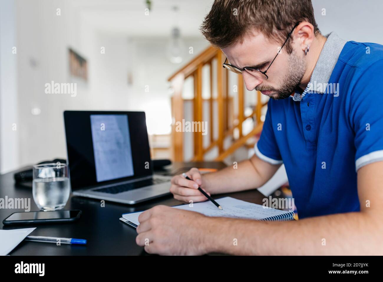 Dedicated young male university student doing math at home Stock Photo ...