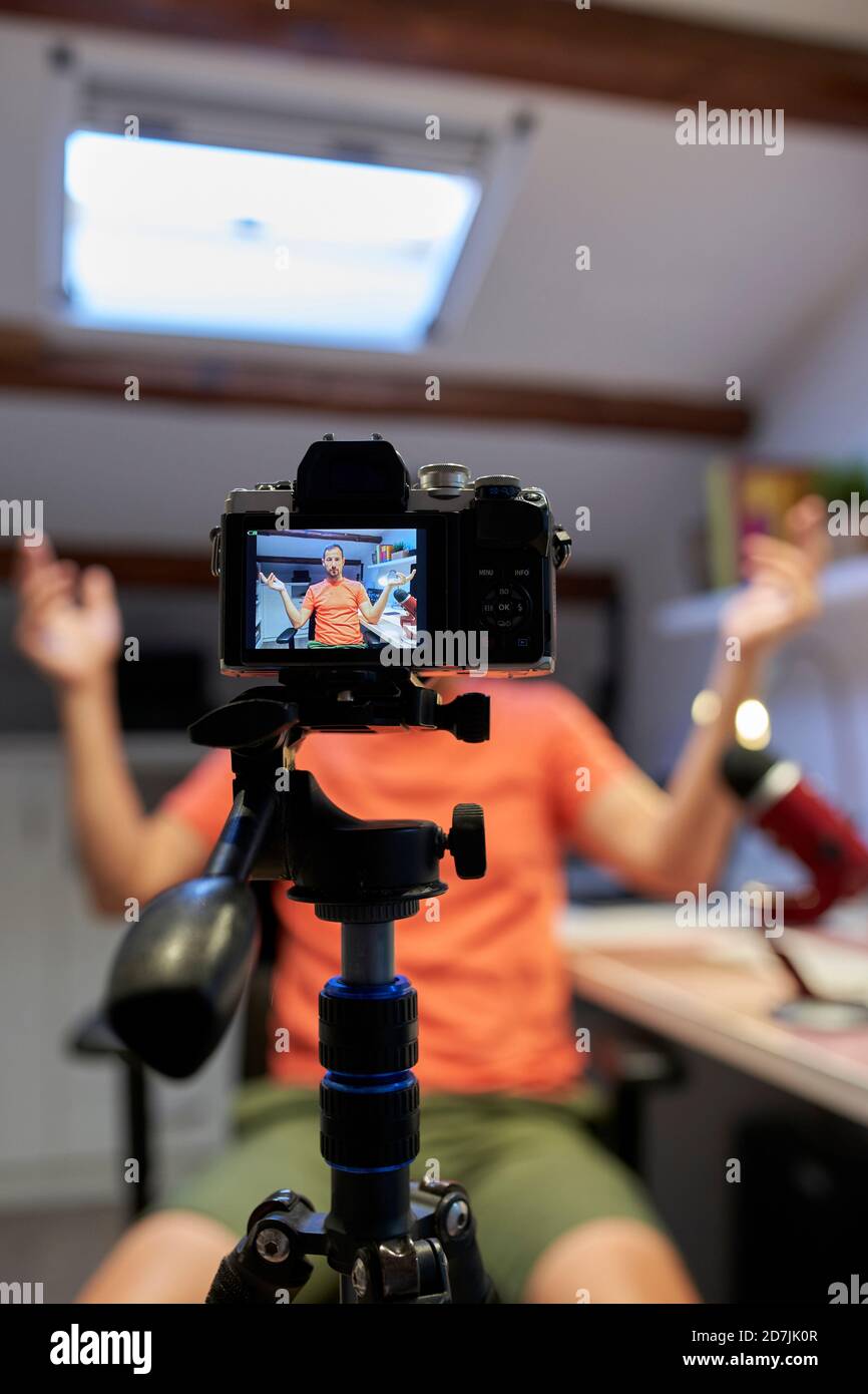 Male influencer recording video tutorial while working from home Stock ...