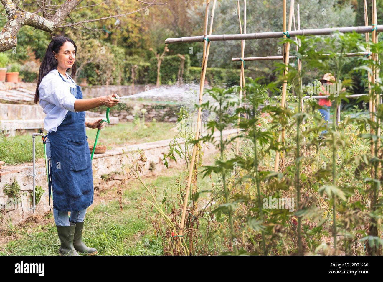 Woman garden hose hi-res stock photography and images - Alamy
