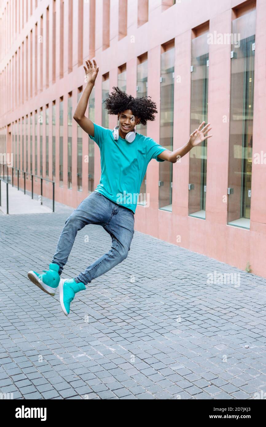 Young black man jumping hi-res stock photography and images - Alamy