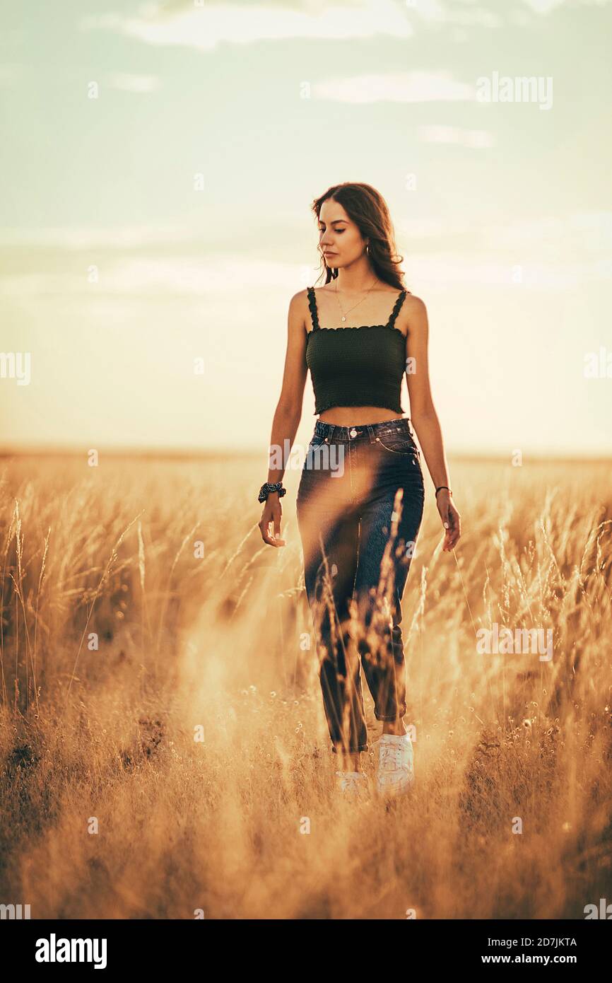 Beautiful young woman walking field hi-res stock photography and images ...