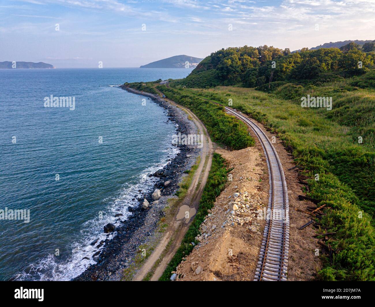 Aerial view of empty railroad tracks stretching along coast of Sea of ...