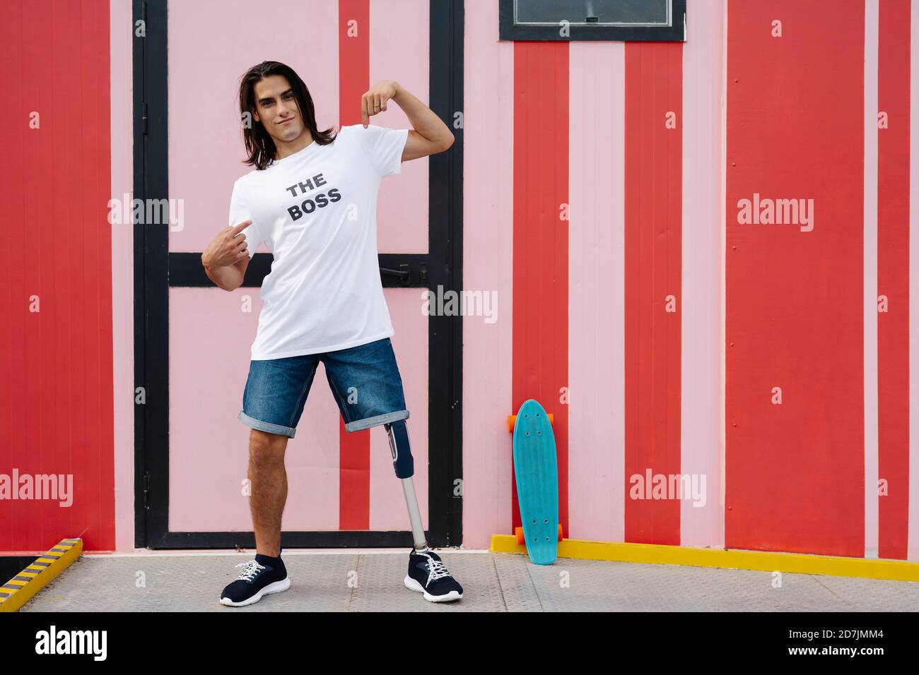 Man pointing himself while standing against multi colored wall Stock ...