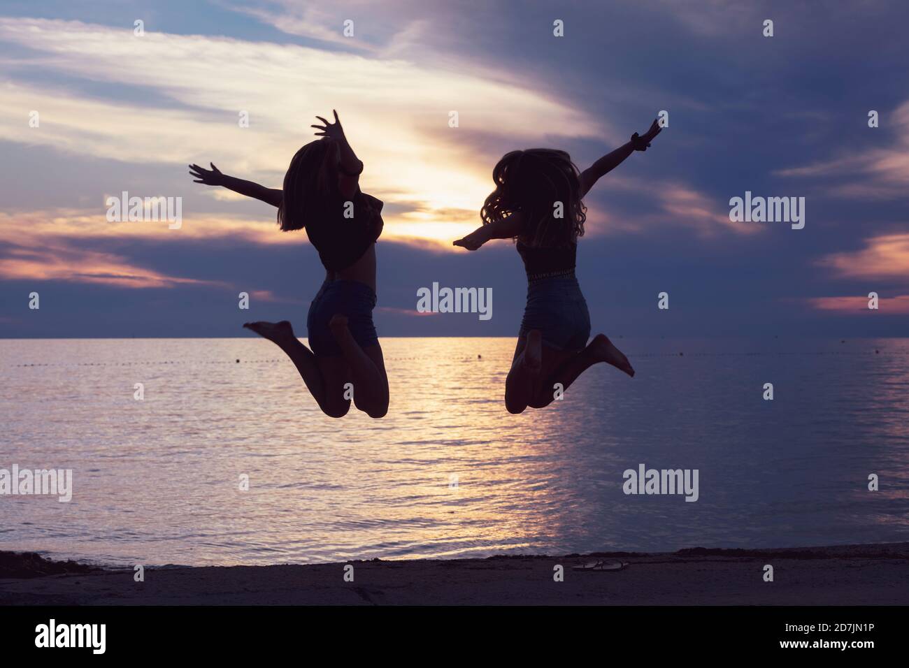 Girls jumping into the sea hi-res stock photography and images - Alamy