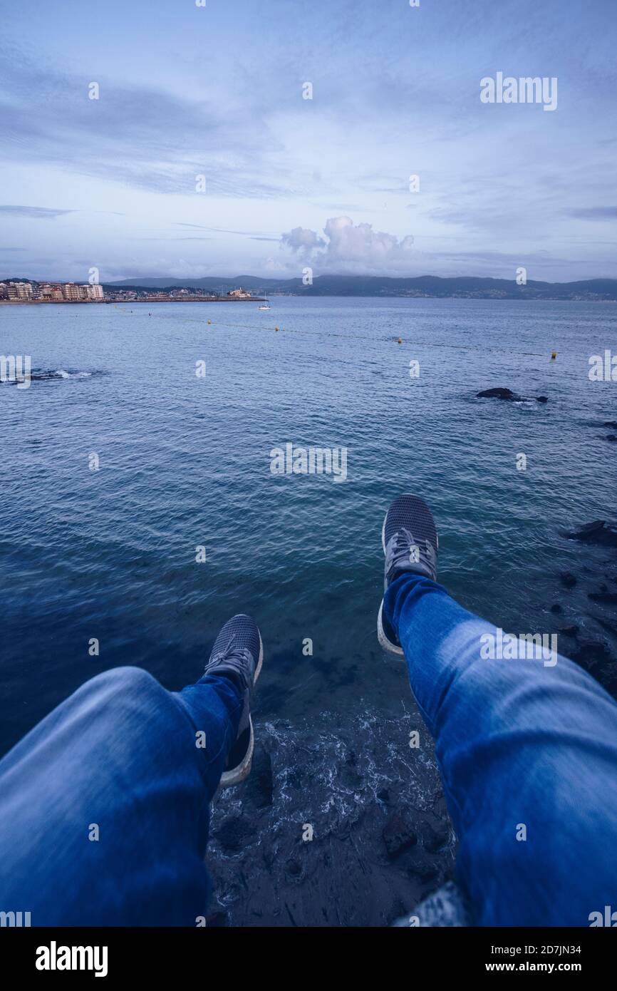 Man dangling legs over water hi-res stock photography and images - Alamy