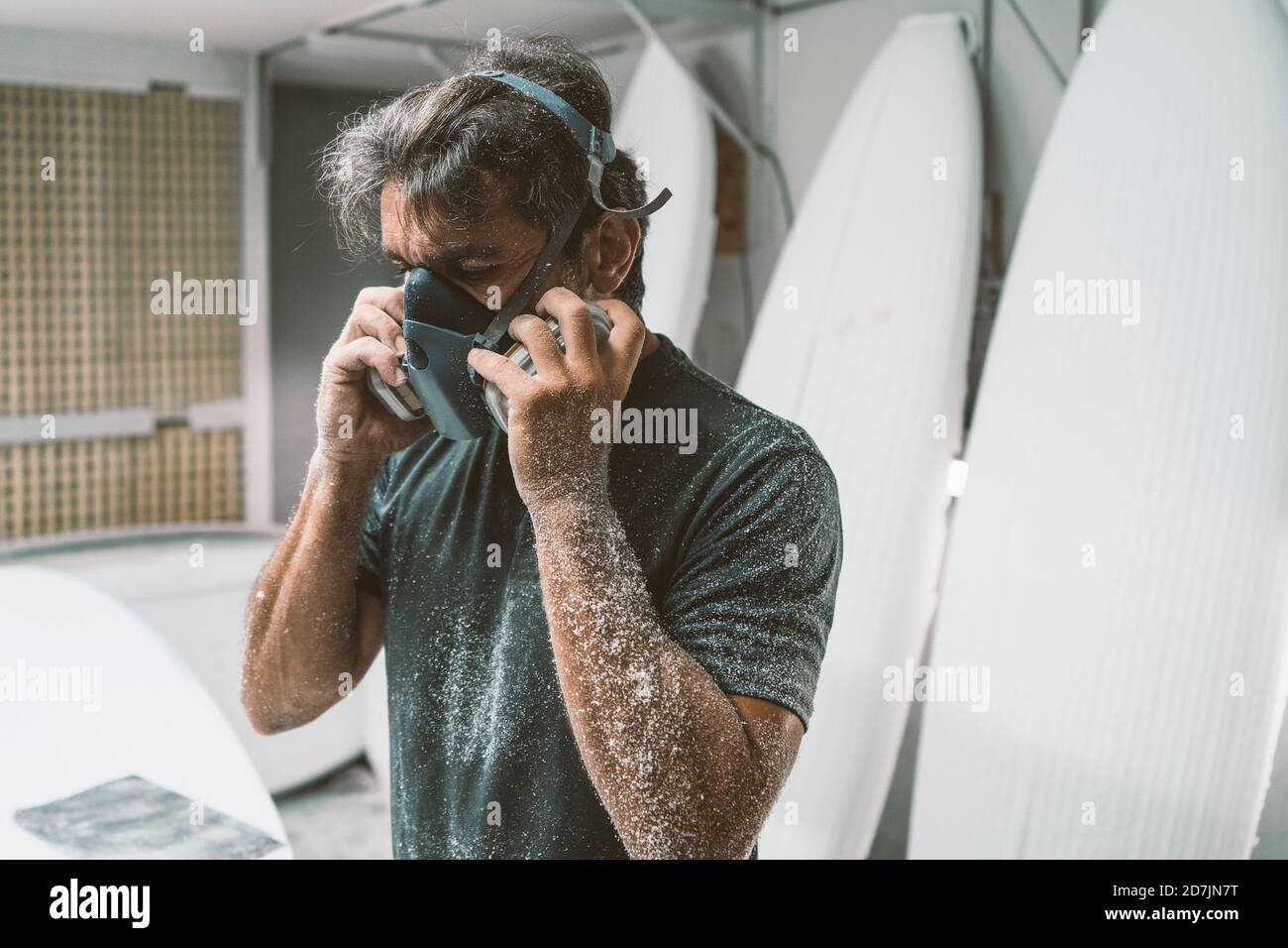 Mature man wearing protective face mask while standing indoors Stock ...