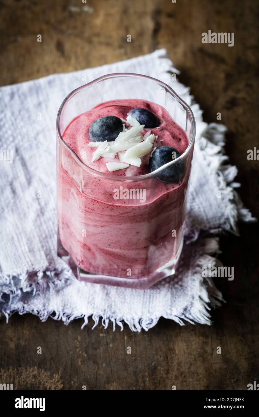 Beautiful garnish of blueberry on blueberry whipped cream kept on table ...