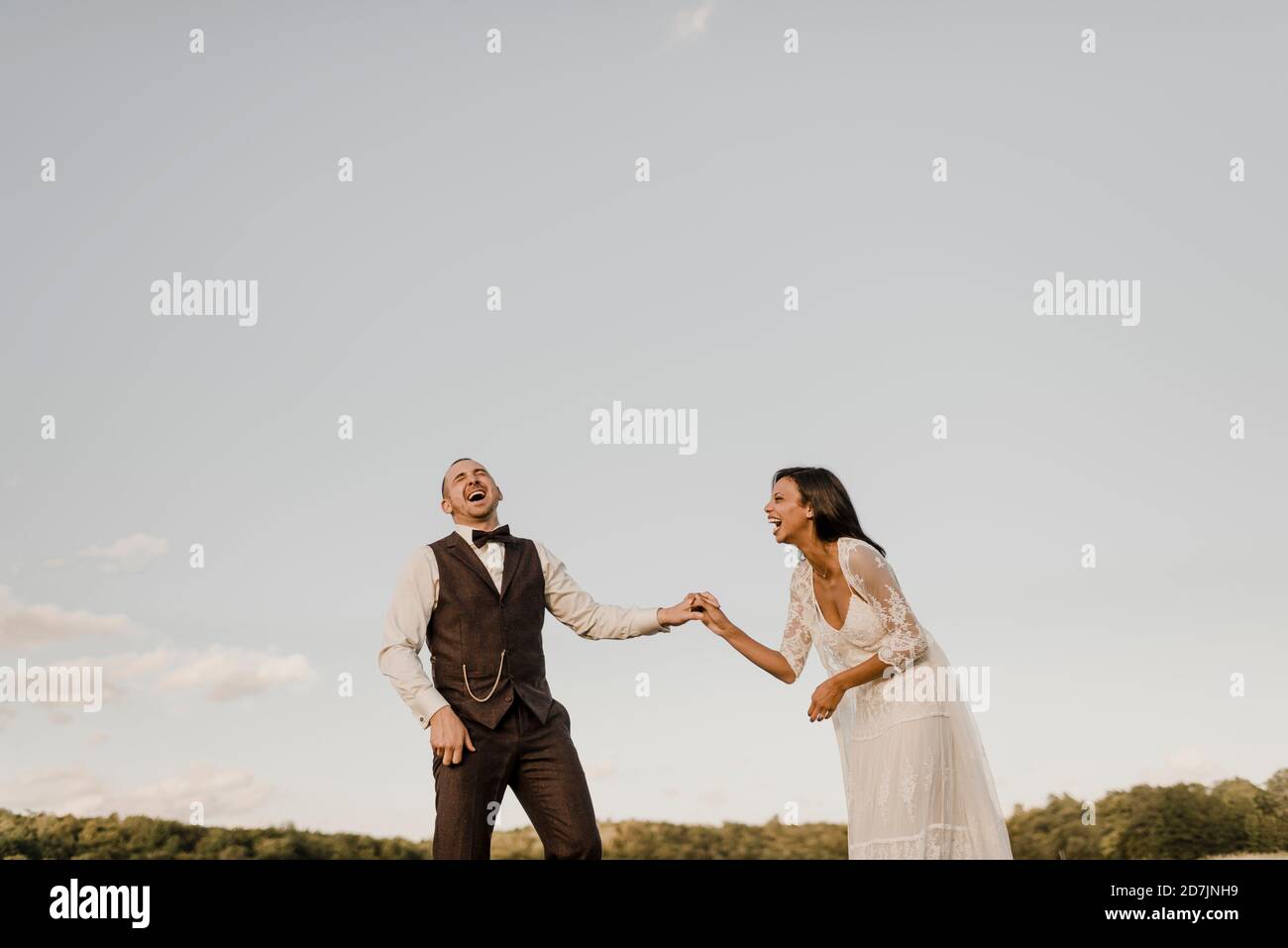 Cheerful couple laughing while standing at agricultural field Stock ...