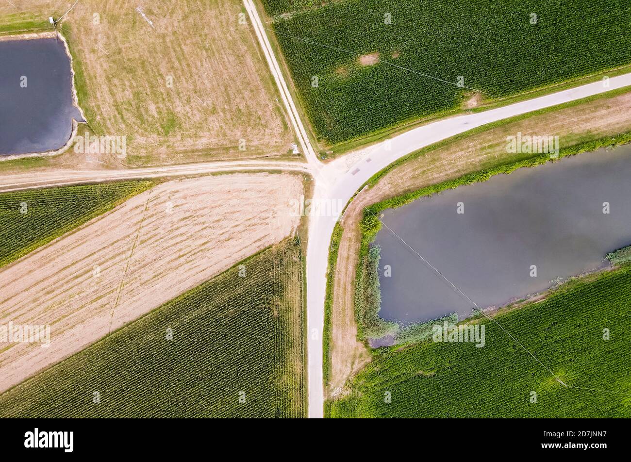Drone view of dirt road stretching between countryside fields Stock ...