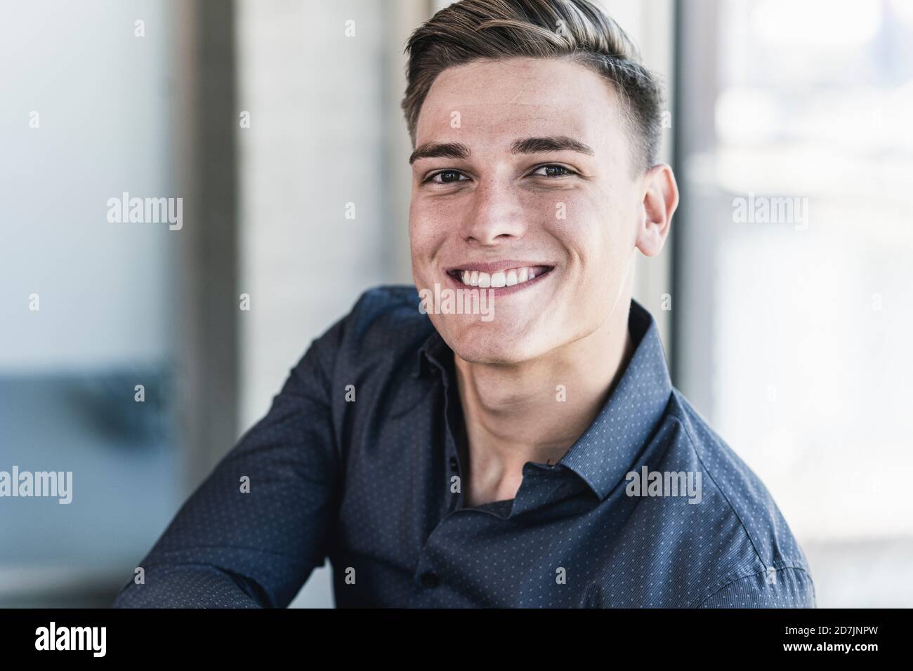 Happy handsome office worker sitting hi-res stock photography and ...