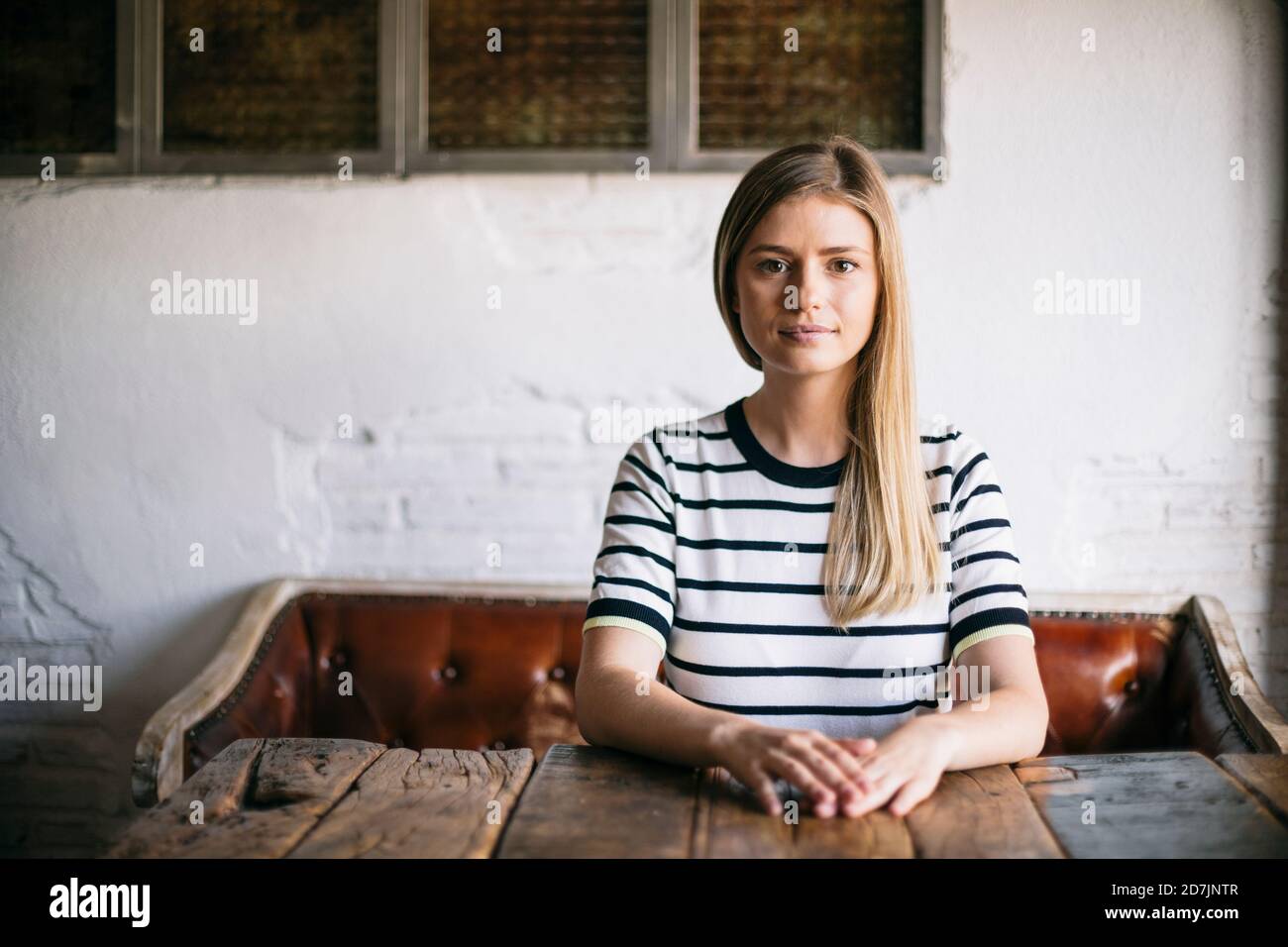 Beautiful woman sitting in cafe Stock Photo - Alamy
