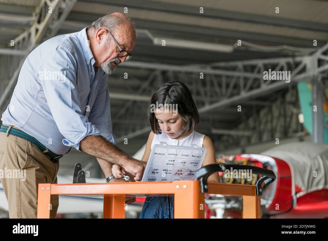 Grandchild and grandfather selecting tools to fix aircraft Stock Photo ...