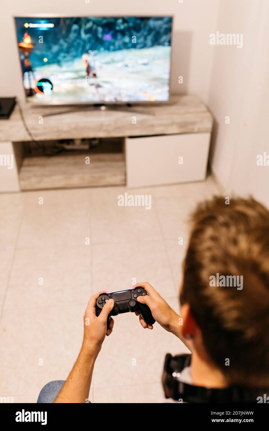 Man enjoying at home while playing video games Stock Photo - Alamy