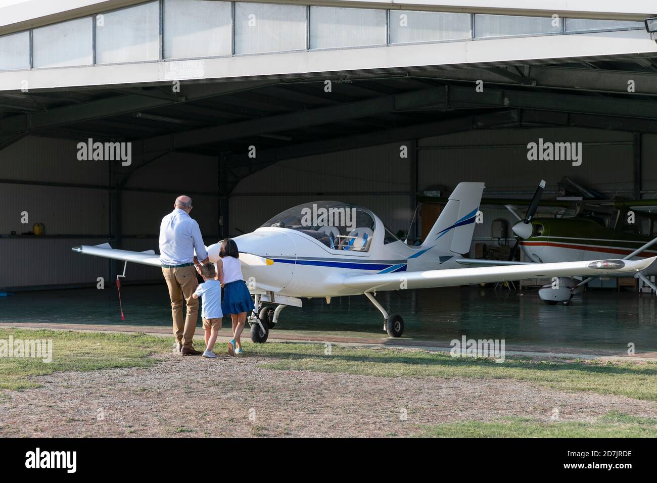 Children and grandfather pulling airplane Stock Photo - Alamy