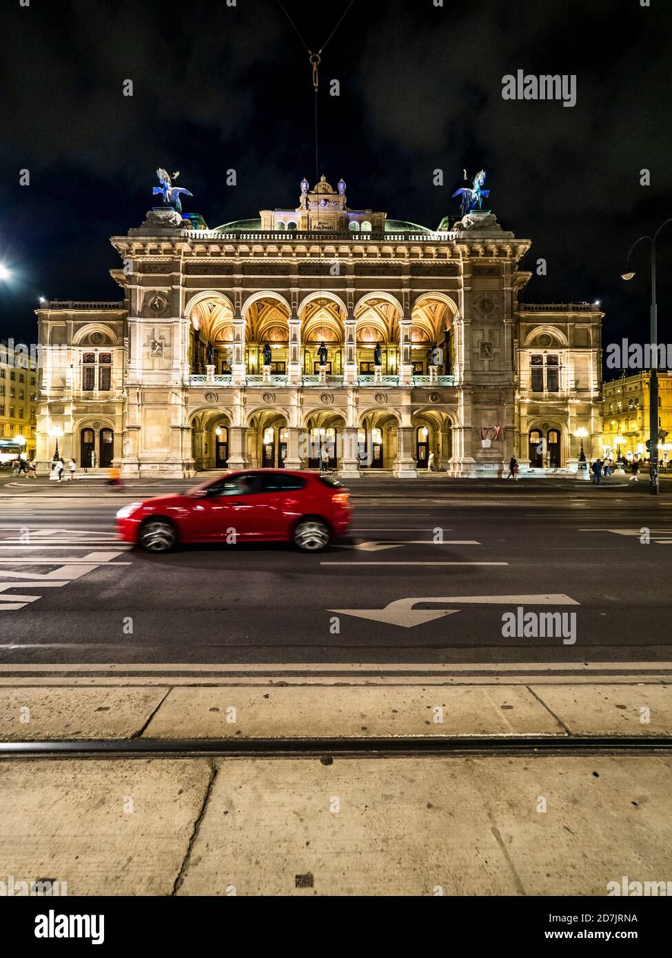 Car driving past vienna state opera at night hi-res stock photography ...