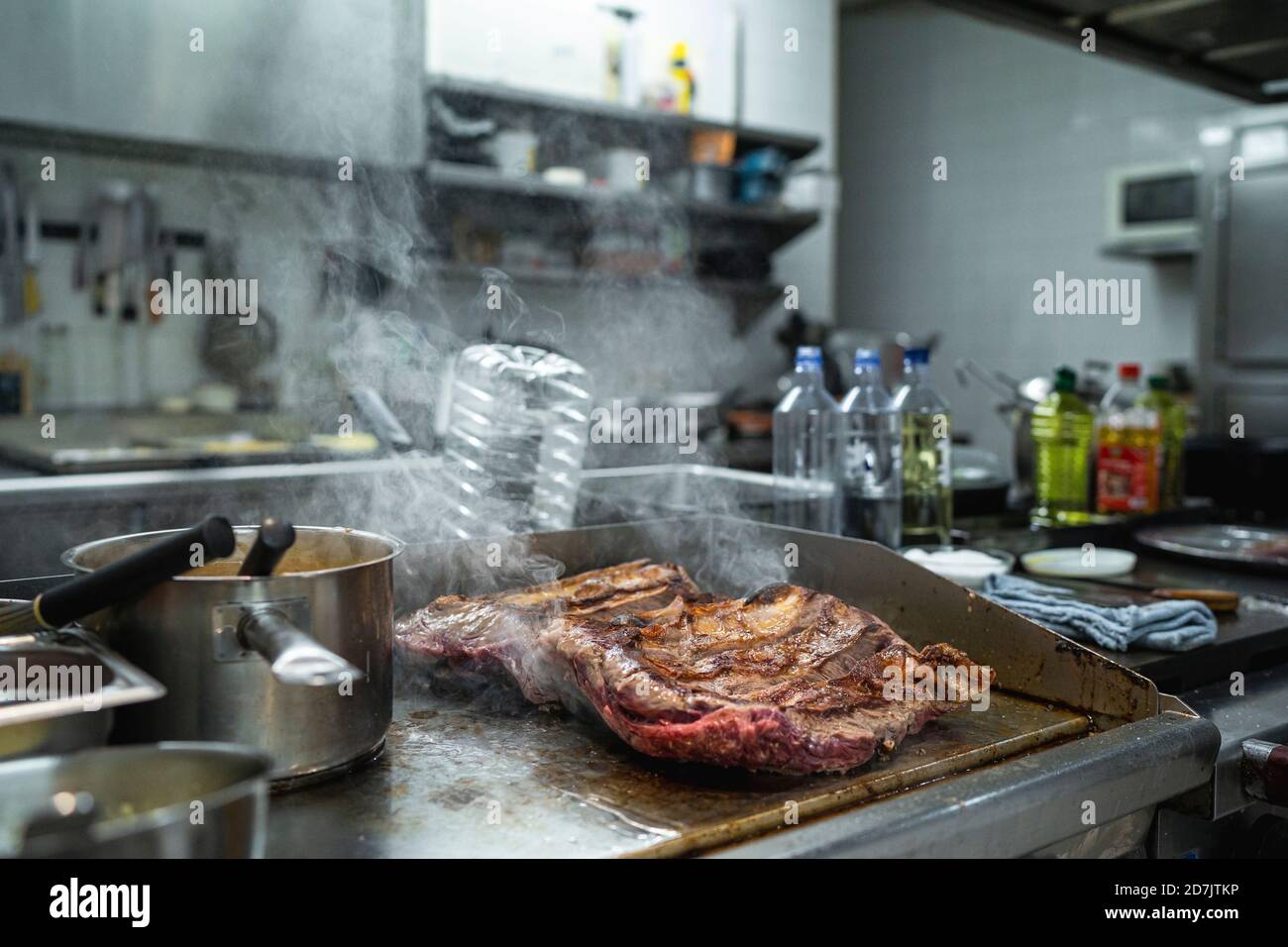 Grilled meat on gas at commercial kitchen Stock Photo - Alamy