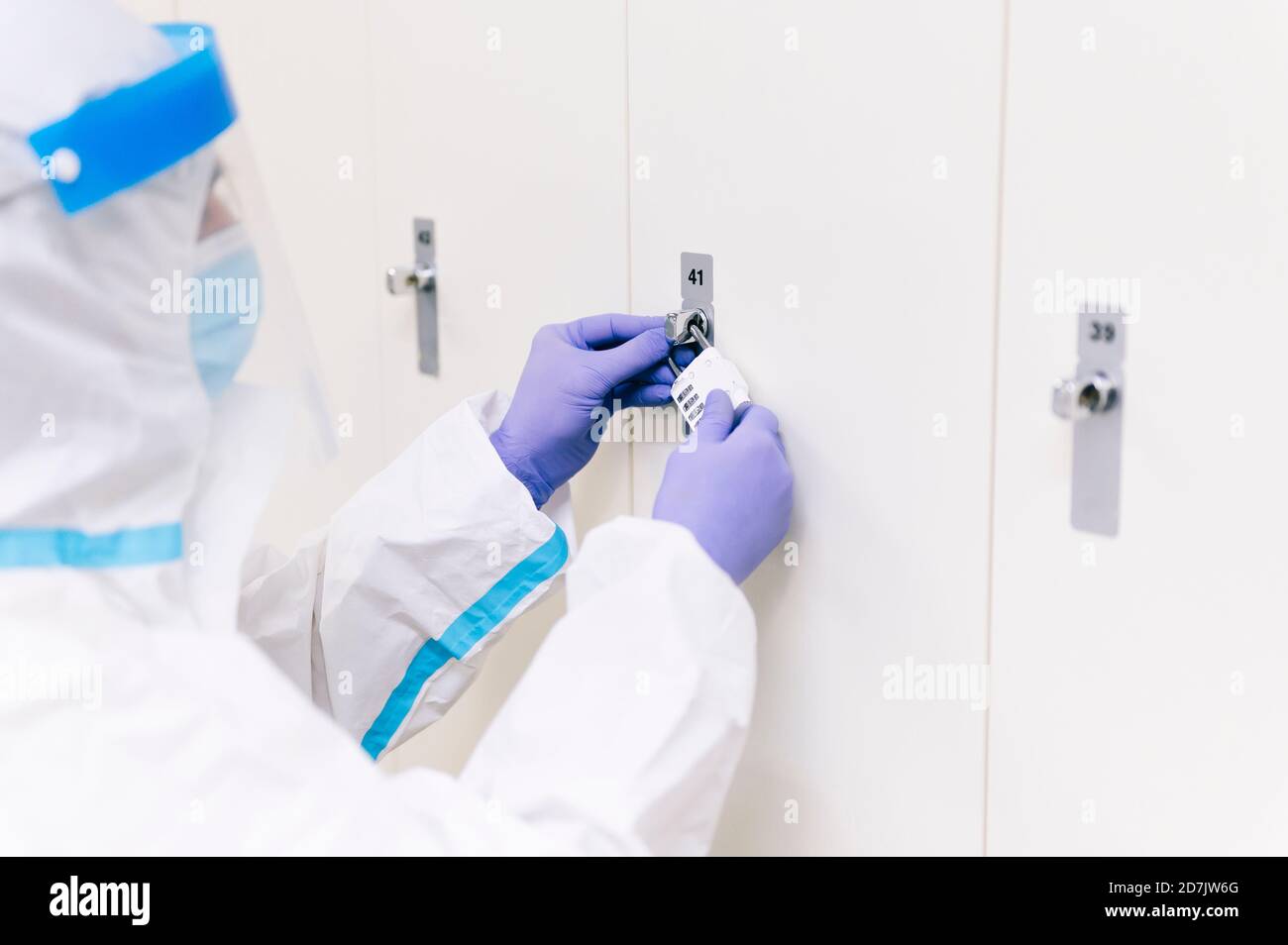 Healthcare man locking locker while standing in hospital Stock Photo ...