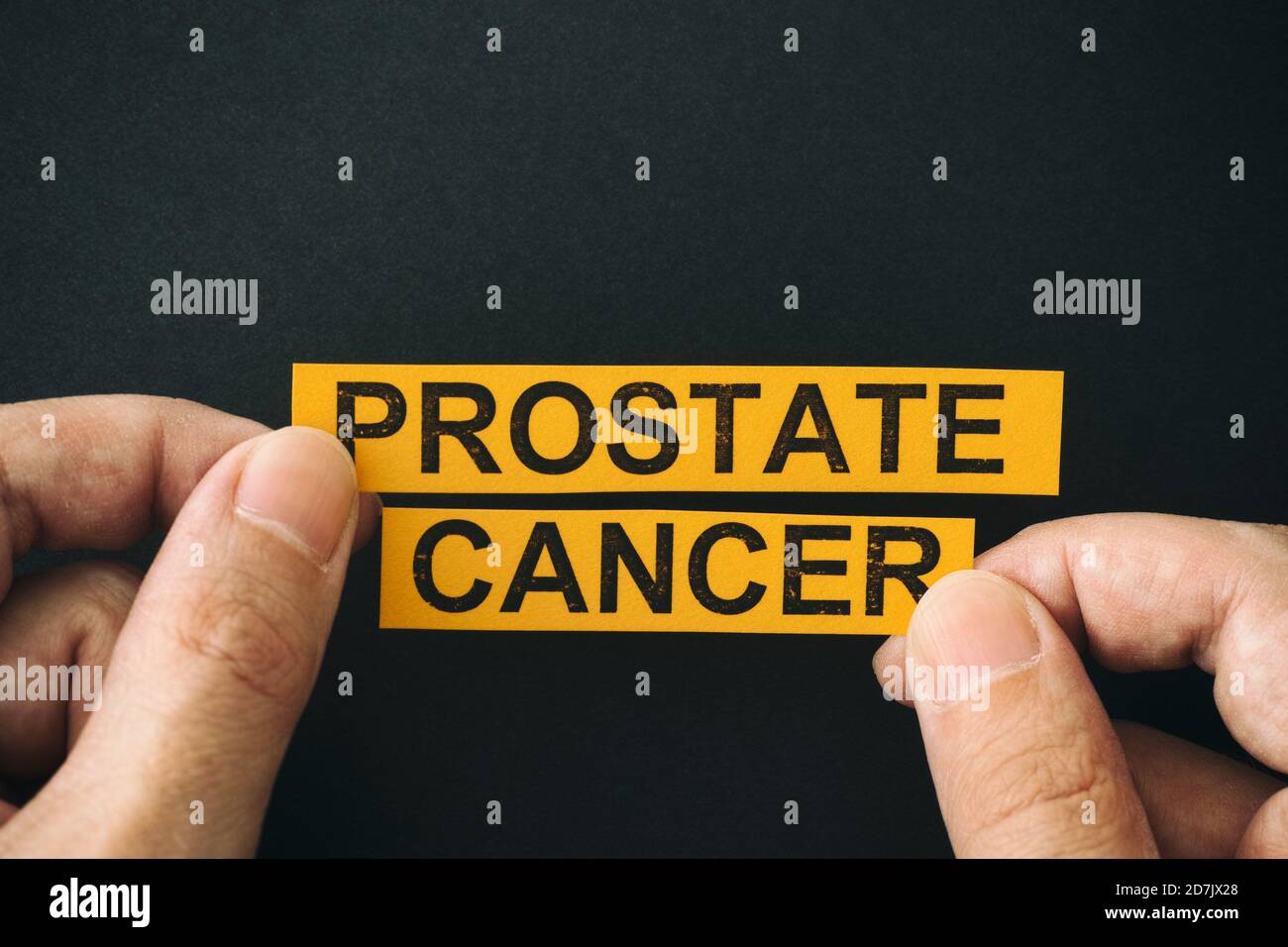 Man holding yellow pieces of paper with the words Prostate Cancer in ...
