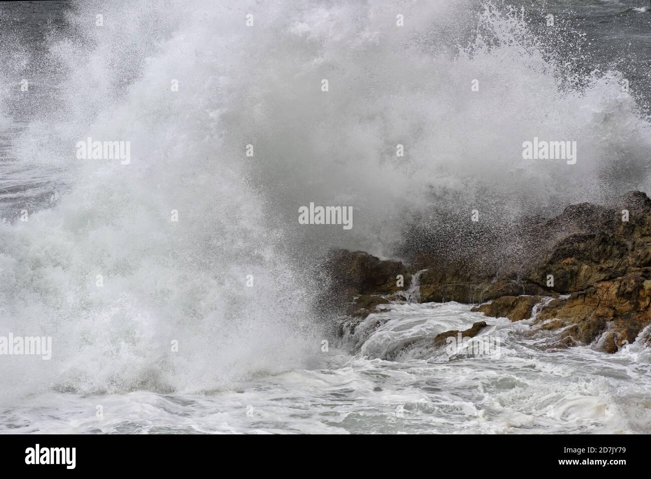 Sea wave breaking over rocks with big splash. Northern portuguese coast ...
