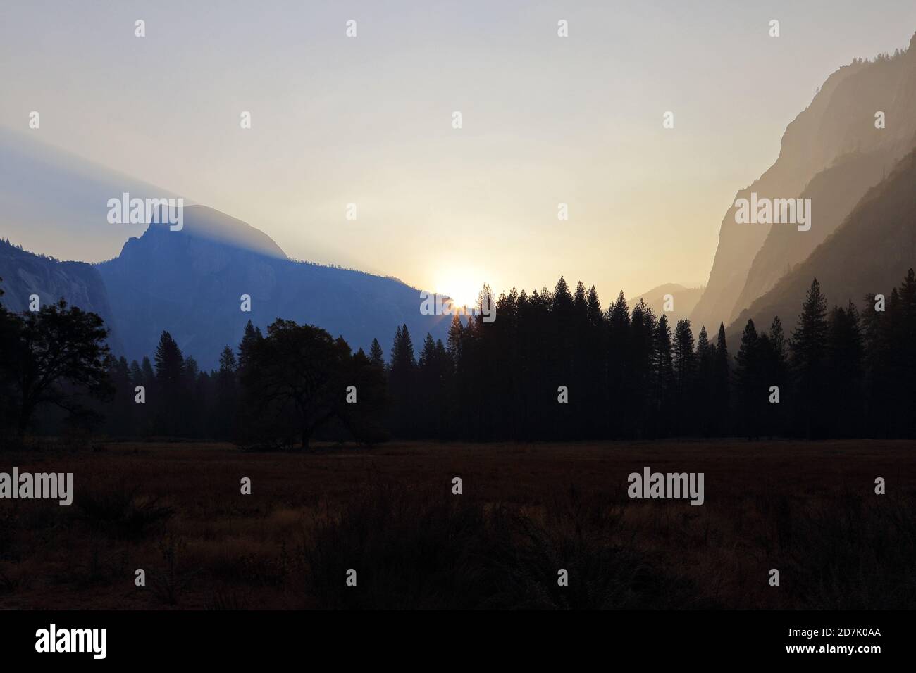 The sun is shown starting to rise over mountains of the Sierra Nevada ...