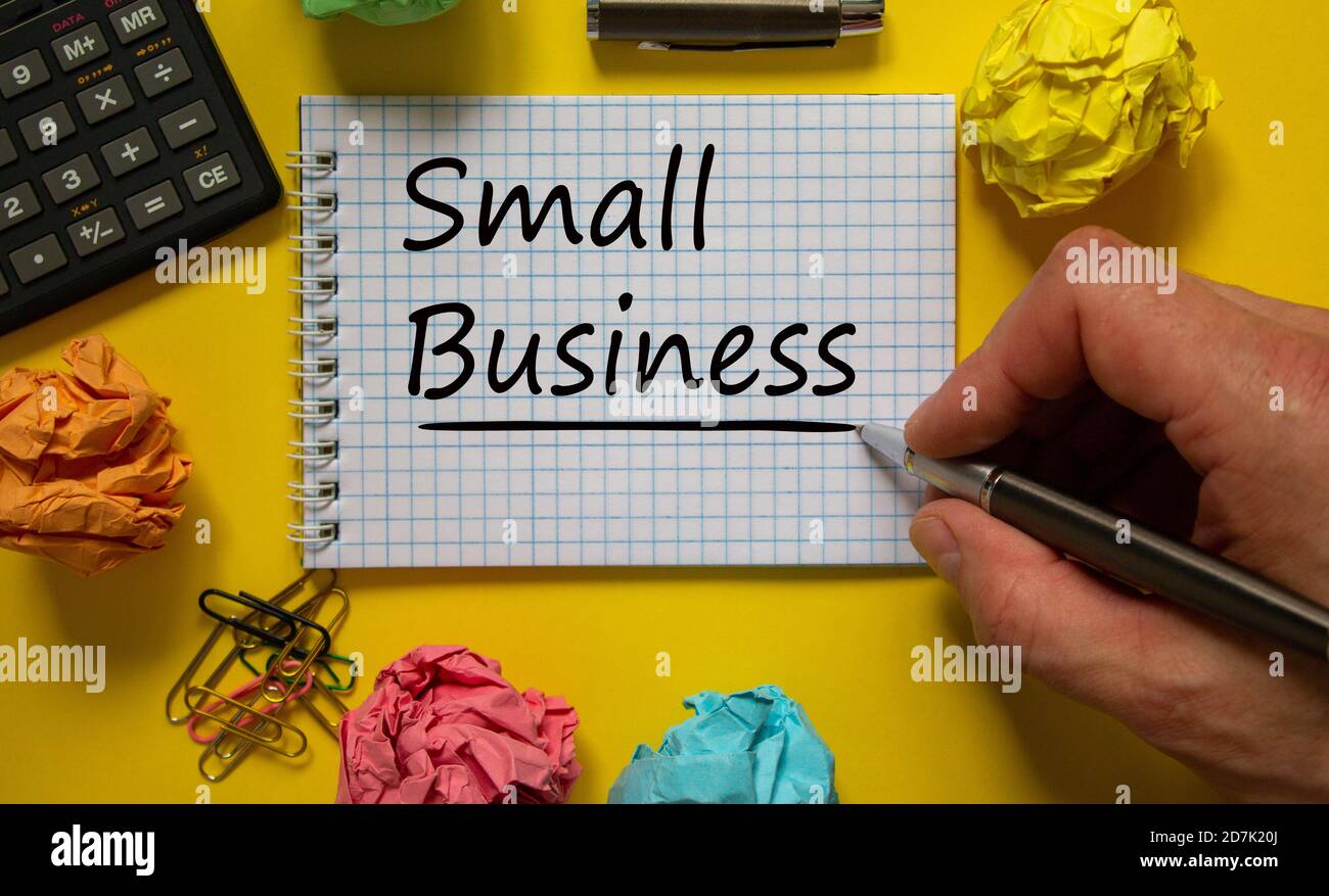 Mail hand writing 'small business' on white note, beautiful yellow ...
