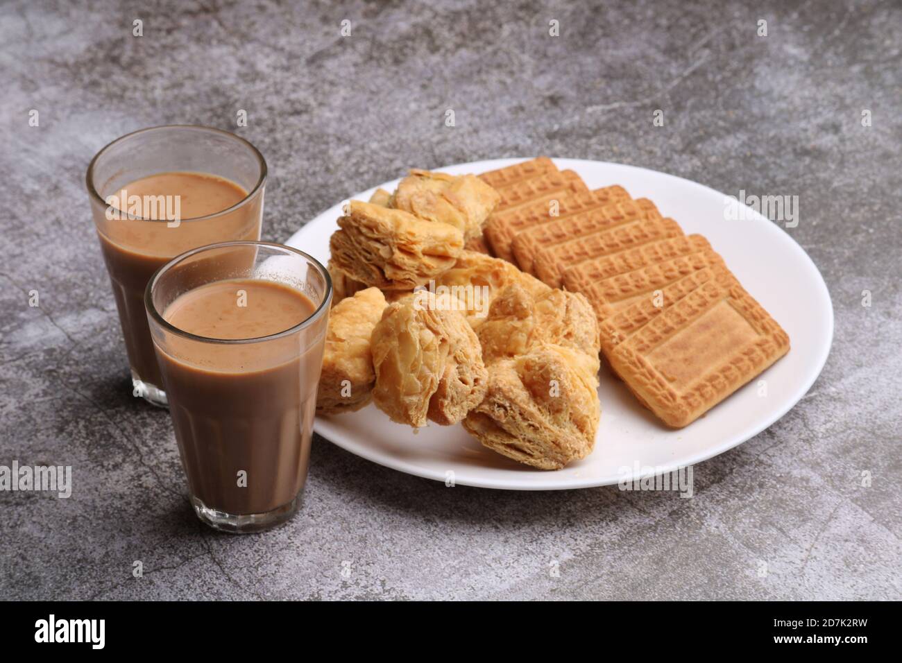 cutting masala chai or tea served with puff pastry/ khari and biscuits ...