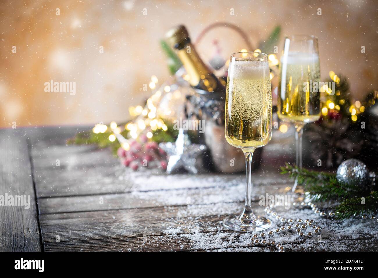Champagne glasses and christmas decor on sparkling holiday background ...