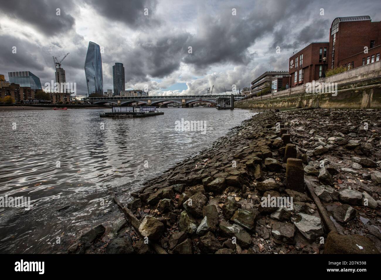 View along the Thames River bank from the foreshore during low tide ...