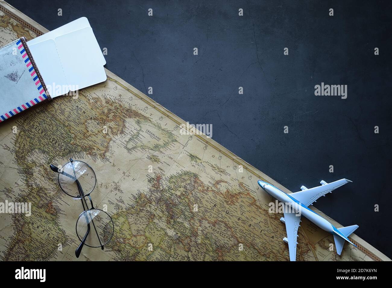 Travel concept. Map on the table andl aircraft Stock Photo - Alamy