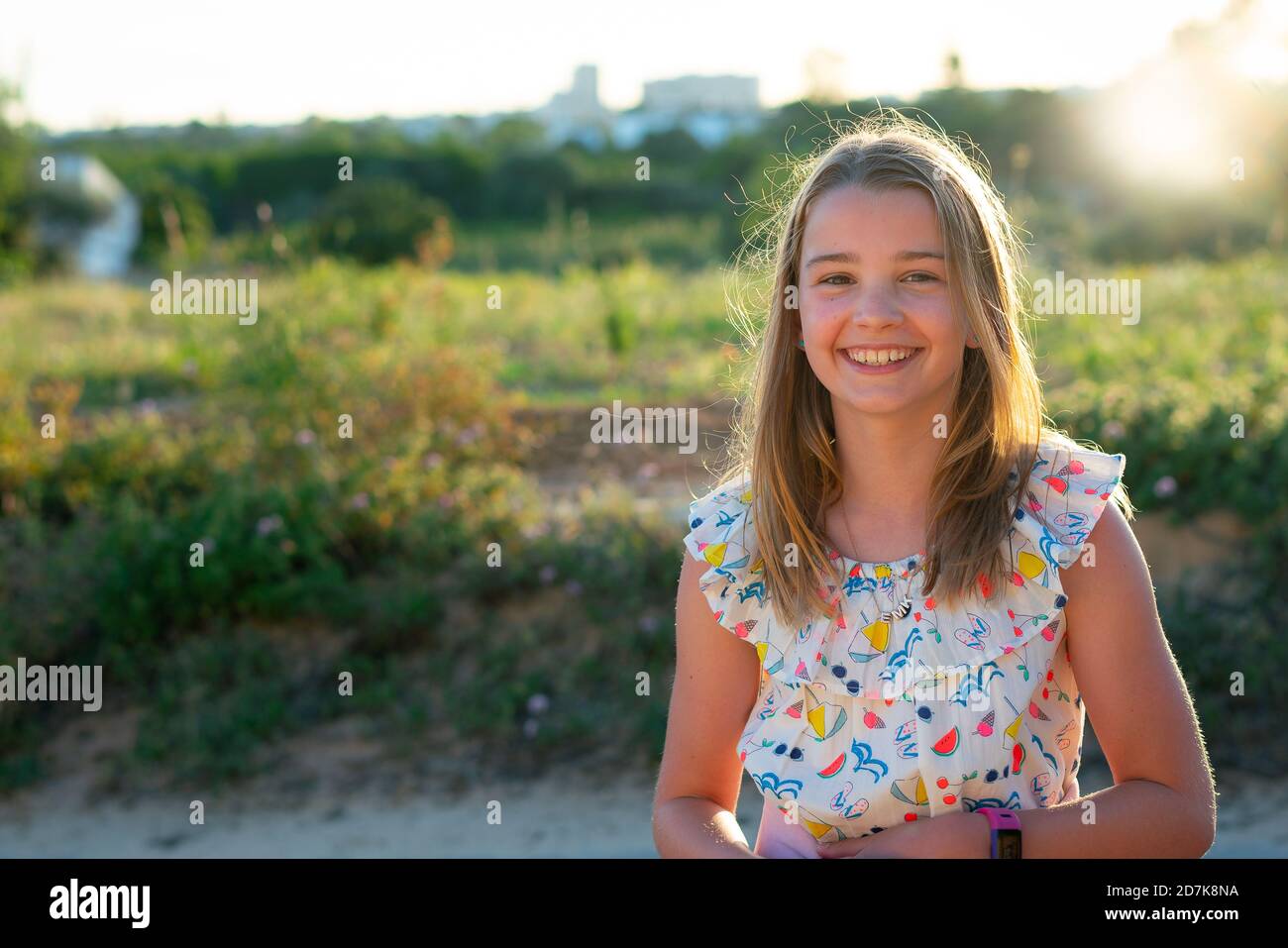 Backlit Smiling Girl in a summer dress Stock Photo - Alamy