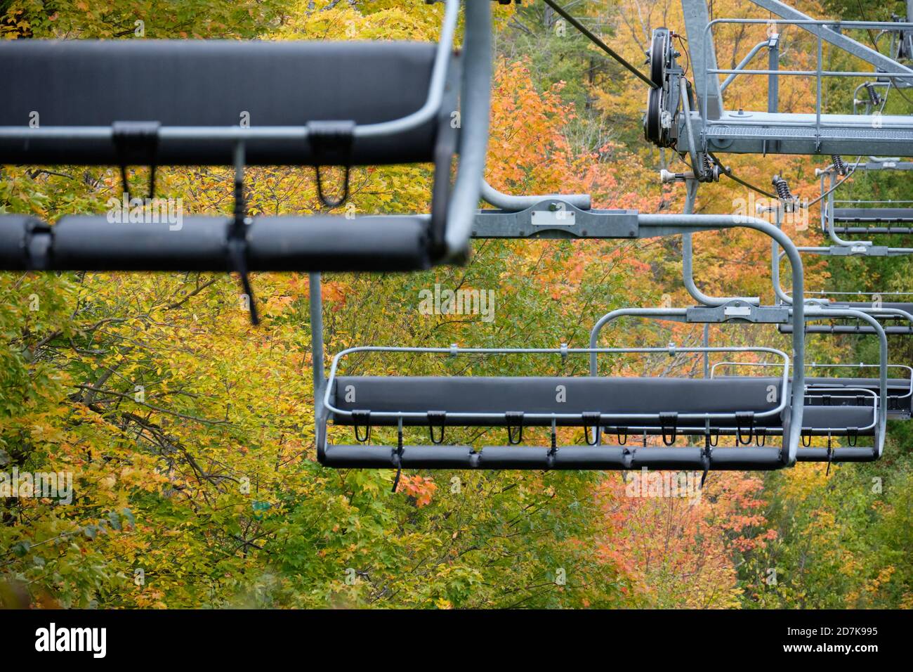 Ski lifts sit unused in the off season - fall - at a ski resort. Bright ...