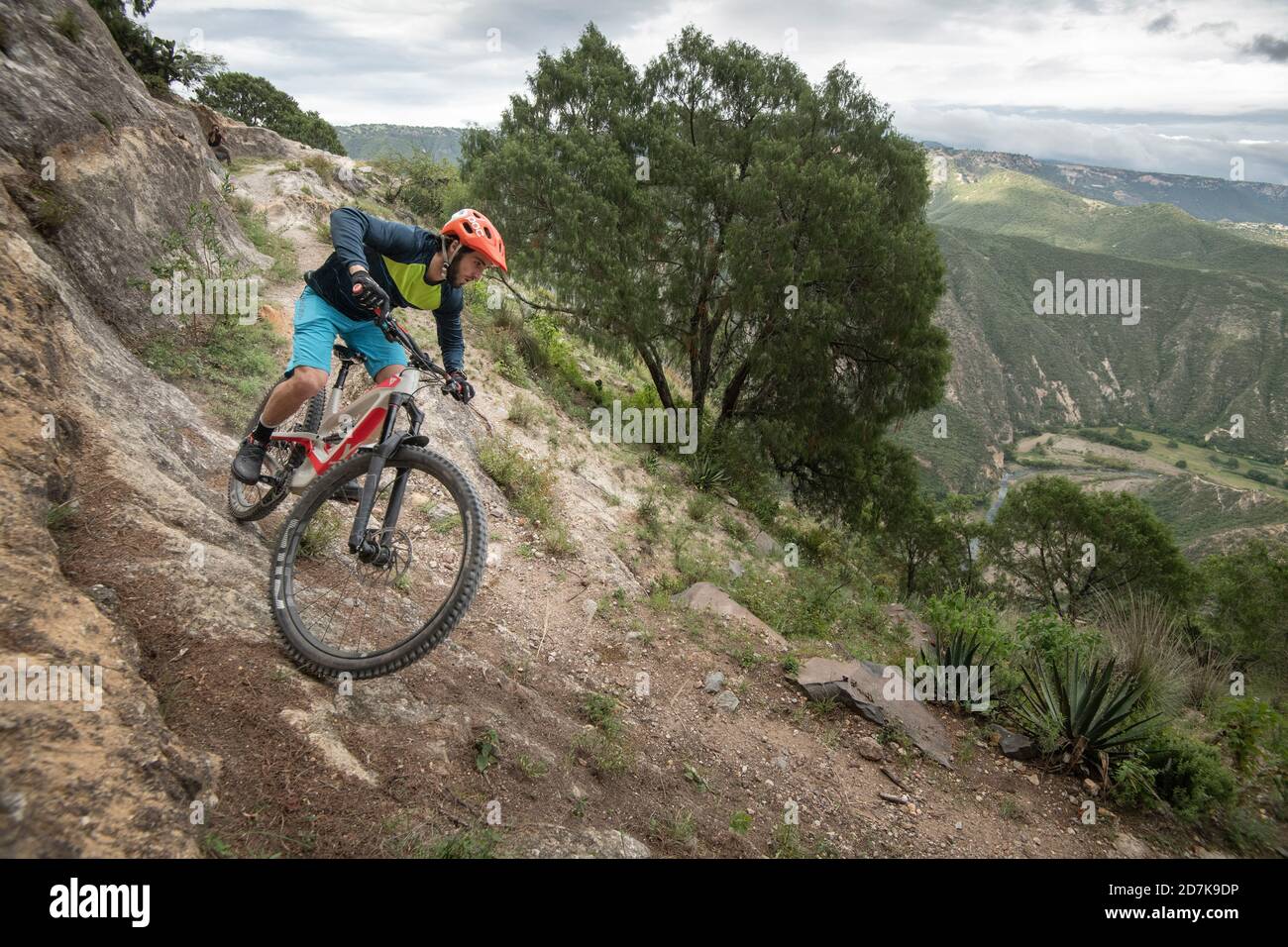 One man riding down a mountain bike on a trail at a canyon Stock Photo ...